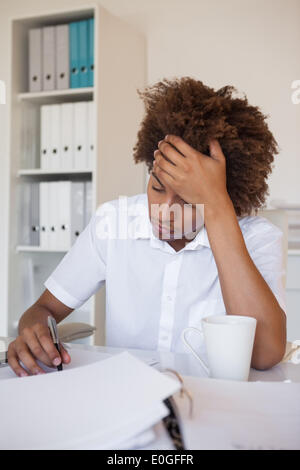 Casual stressed businessman writing at his desk Stock Photo - Alamy