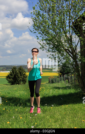 woman jogging through the fields at the springtime Stock Photo - Alamy