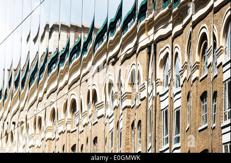Distorted reflection of the facade of the building in the windows of ...