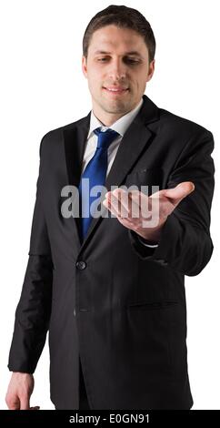Handsome businessman holding hand out Stock Photo - Alamy