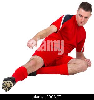 Fit football player playing and kicking ball Stock Photo - Alamy