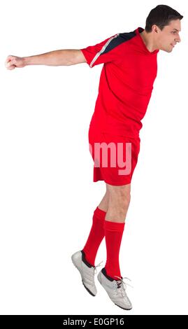 Fit football player jumping up on white background Stock Photo - Alamy