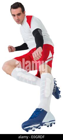 Football player in white kicking against argentina flag in grunge ...