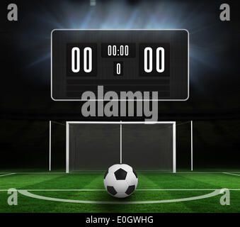 Black scoreboard with no score and football against football pitch in ...