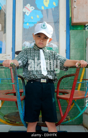 little indonesian schoolboy proudly posing in his school uniform in a ...