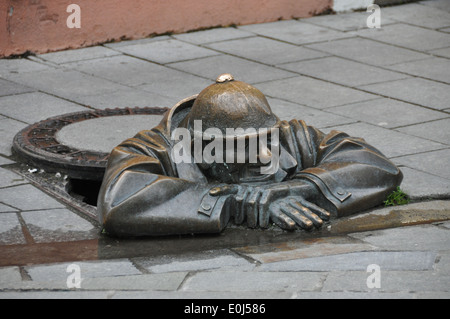 Bronze sculpture of a man in a manhole called "Man at Work" in ...