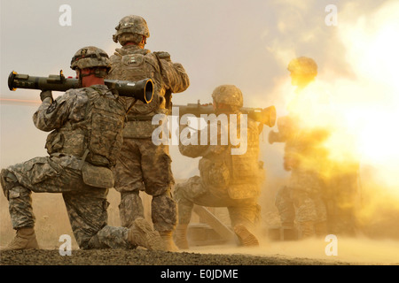 The firing line is illuminated by the backblast flash of an 84 mm ...