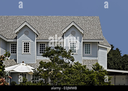 Dormer window and shingled roof construction with wood clad facade ...