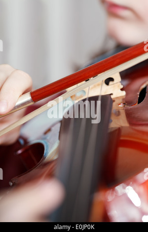child plays on fiddle by bow close up Stock Photo - Alamy