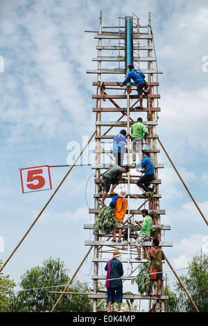 Yasothon, Thailand. 11th May, 2014. A Buddhist monk looks up as a ...