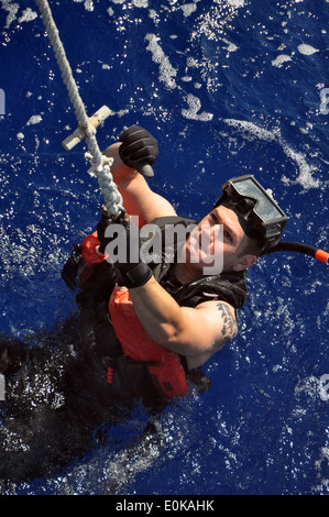 Petty Officer 2nd Class Collin Brayerton, a crewmember from Coast Guard ...
