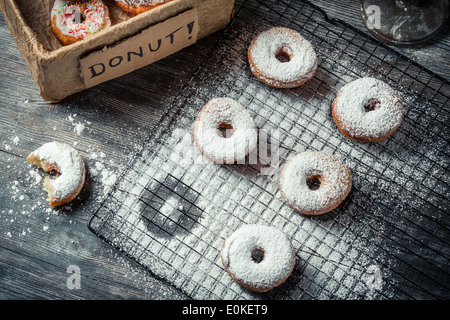 Tasting freshly baked donuts Stock Photo - Alamy