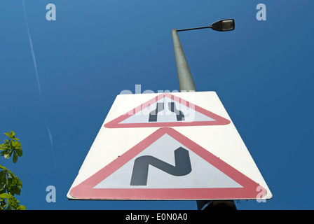 Double bend first to right road sign in Britain Stock Photo - Alamy