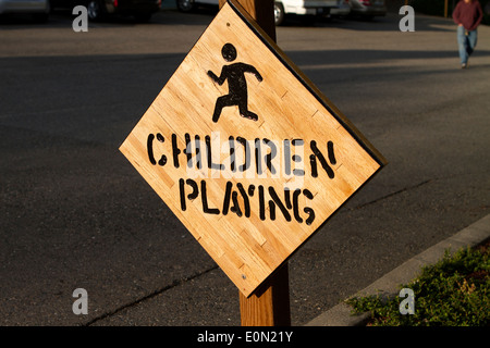 Wooden Children playing warning sign Stock Photo - Alamy