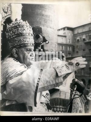 Pope John XXIII, wearing the triple-crowned tiara of the papacy sits on ...