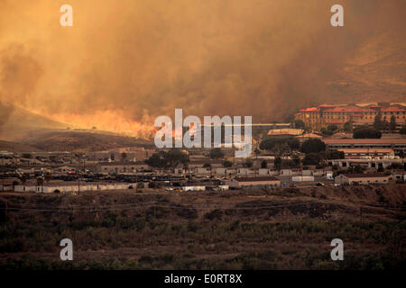 The Las Pulgas wildfire burns along a roadway in the foothills around ...