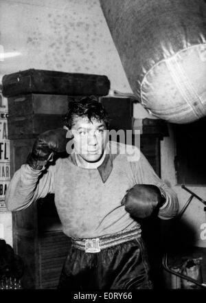 Boxing fighter hits punching bag in the gym Stock Photo - Alamy