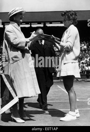 Tennis player Shirley Fry Irvin shakes opponent's hand Stock Photo - Alamy