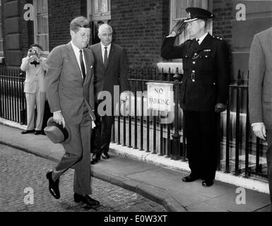 Man police officer smiling salutes hand to forehead on street beside ...
