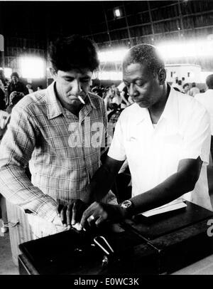 Volunteer helps Cuban refugee fingerprint Stock Photo - Alamy