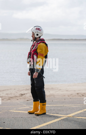 Male RNLI inshore rescue lifeboat crew member wearing full safety ...