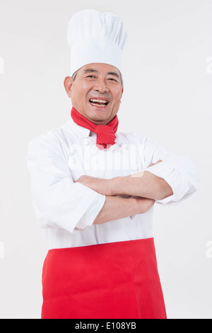 an old man wearing a chefs uniform Stock Photo - Alamy