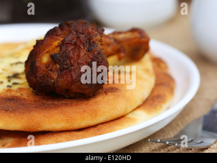 Garlic nan with grilled chiken on serving plate Stock Photo - Alamy