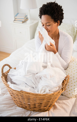 Laundry, fresh and woman smelling clean clothes with a smile, peace and ...