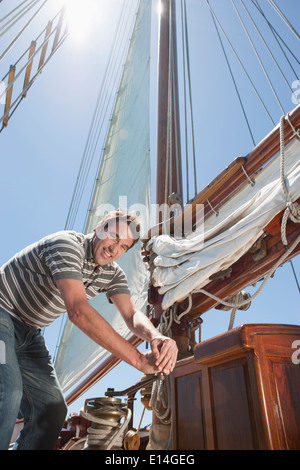 Hoisting sail in a boat Stock Photo - Alamy