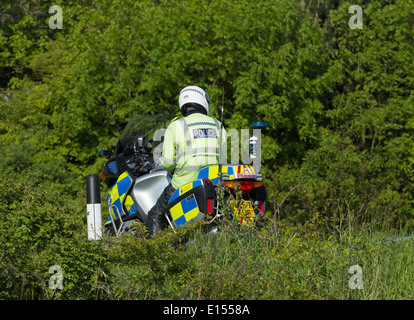 Police motorcycle in layby on Dual Carriageway with Royal Mail truck ...