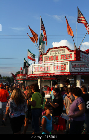 A crowd of people at a french fries stand at the Minnesota State Fair ...