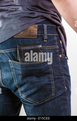 Careless man putting wallet in pocket Stock Photo - Alamy