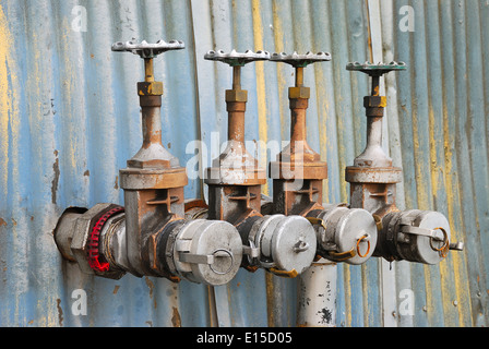 Old fuel transfer valves on a building in the industrial area. Stock ...