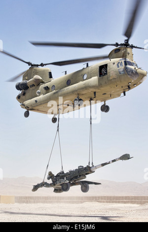 A CH-47 Chinook helicopter lifts a M777 towed 155mm howitzer at Al Qa ...