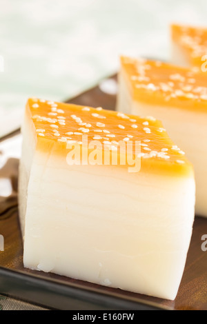 Layered Chinese rice cakes with sesame seed topping Stock Photo - Alamy