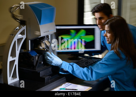 Scientists using an Alicona InfiniteFocus 3D surface measurement device ...