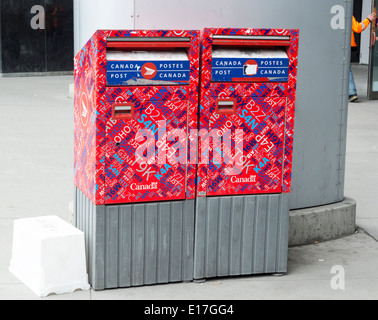 2 Canda Post Mailboxes covered in postal codes side by side in downtown ...