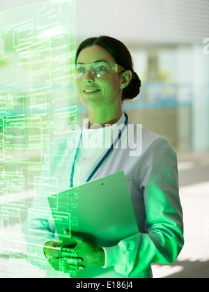 Smiling scientist in white coat smiling at camera in lab Stock Photo ...