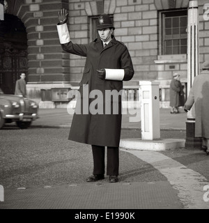 1960s, historical, a British policeman wearing helmet, overcoat, gloves ...