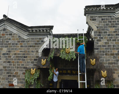 Zigui, Yichang, China . 28th May, 2014. People hang mugwort leaves at ...