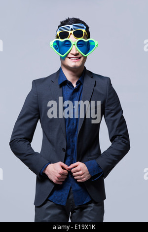 Hip young man wearing multiple pairs of sunglasses Stock Photo - Alamy