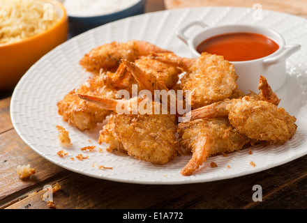 Dipping fried fish into sauce Stock Photo - Alamy