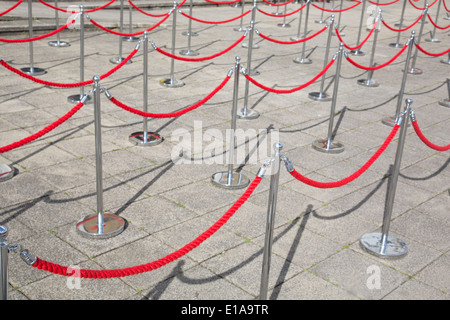Red rope barriers cordon off an area where a queue will form to help ...