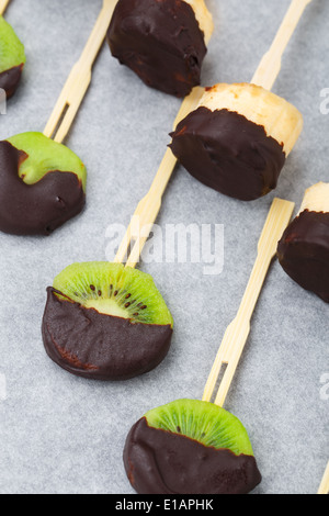 Fruits with chocolate on a stick Stock Photo - Alamy