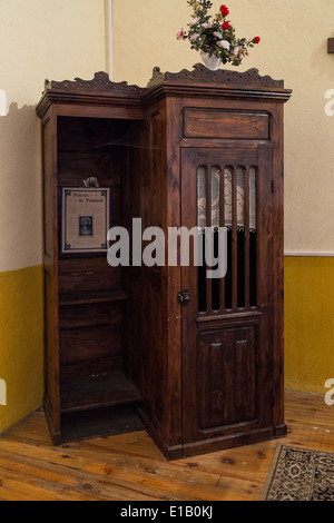 Old Catholic church wooden confession box with open door and green ...