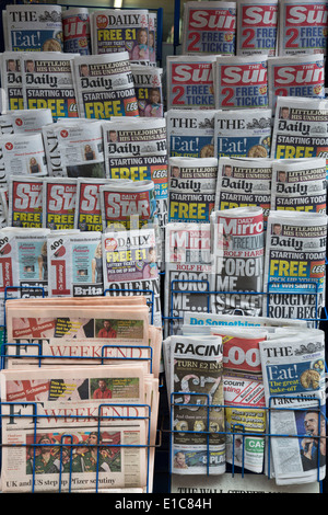 Stand of tabloid newspapers at a newsagents. London, UK. The Sun, the ...