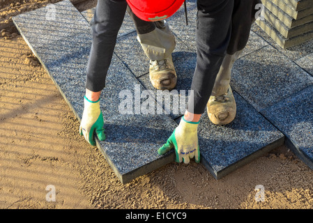 paviours at work in street in town Stock Photo - Alamy