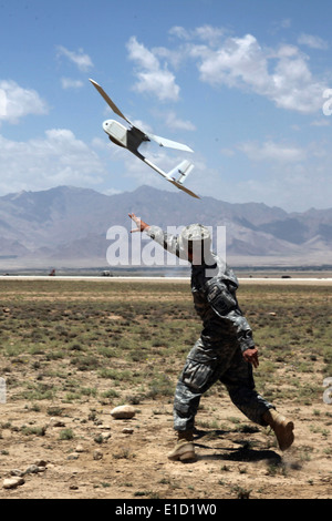 A US Army soldier launches a RQ-11B Raven unmanned aerial system before ...