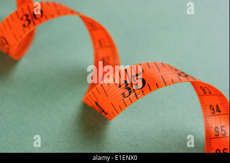 Orange sartorial meter on a green background Stock Photo - Alamy