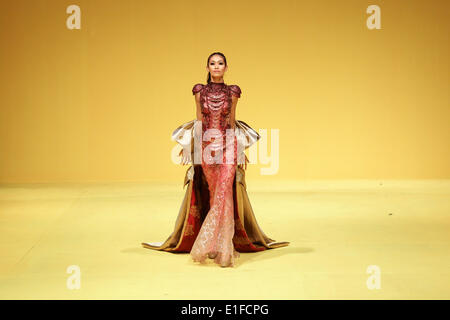 A model presents a creation of Philipp Tampus during the Philippine ...